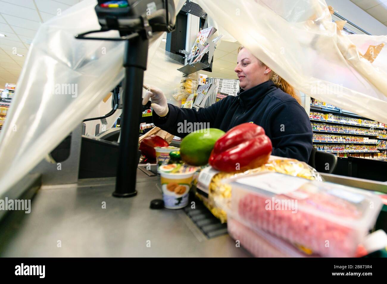 Langballig, Germany. 20th Mar, 2020. Cashier Bianca Krüger scans goods ...