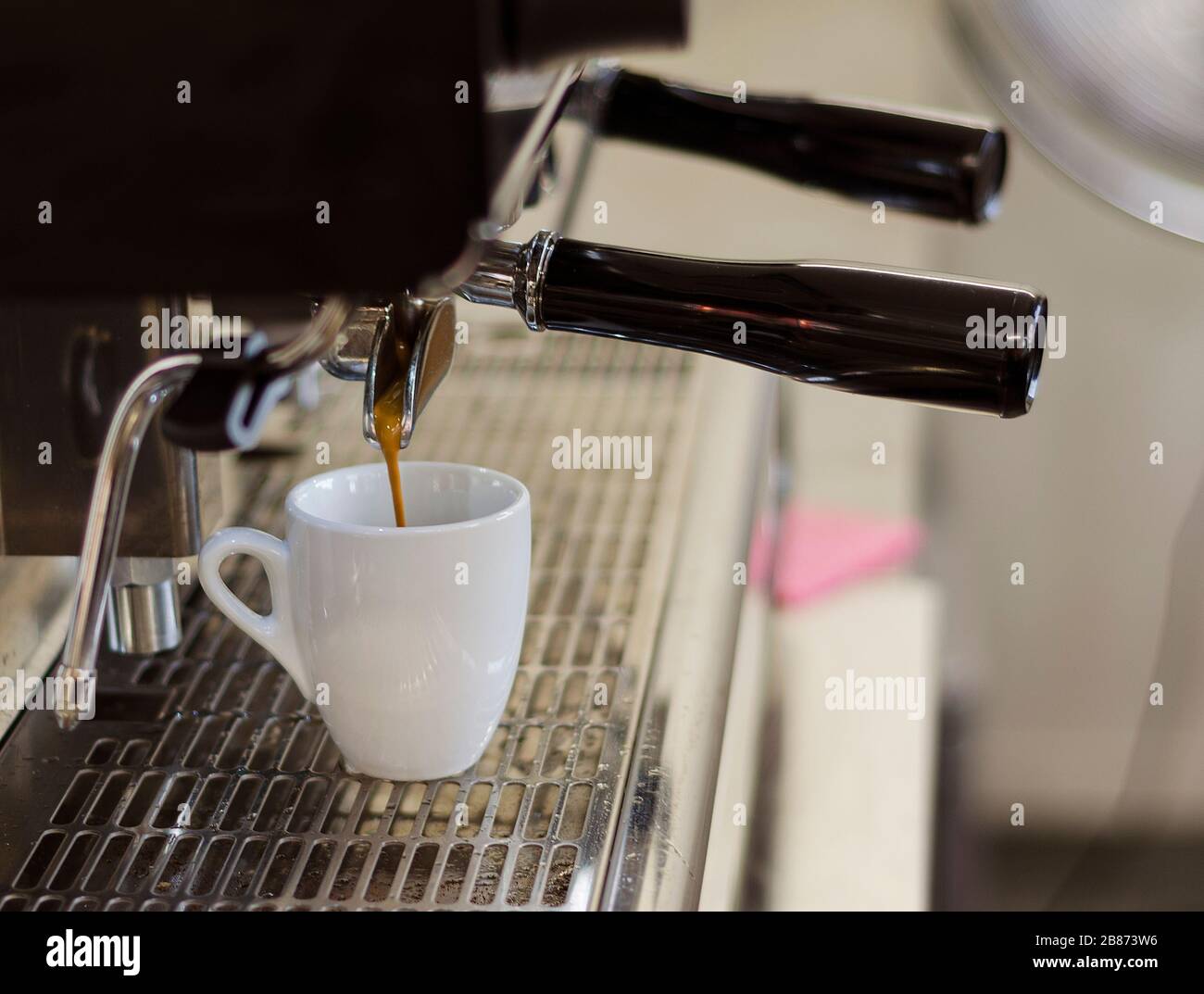 coffee flows from a coffee machine into a cup Stock Photo - Alamy