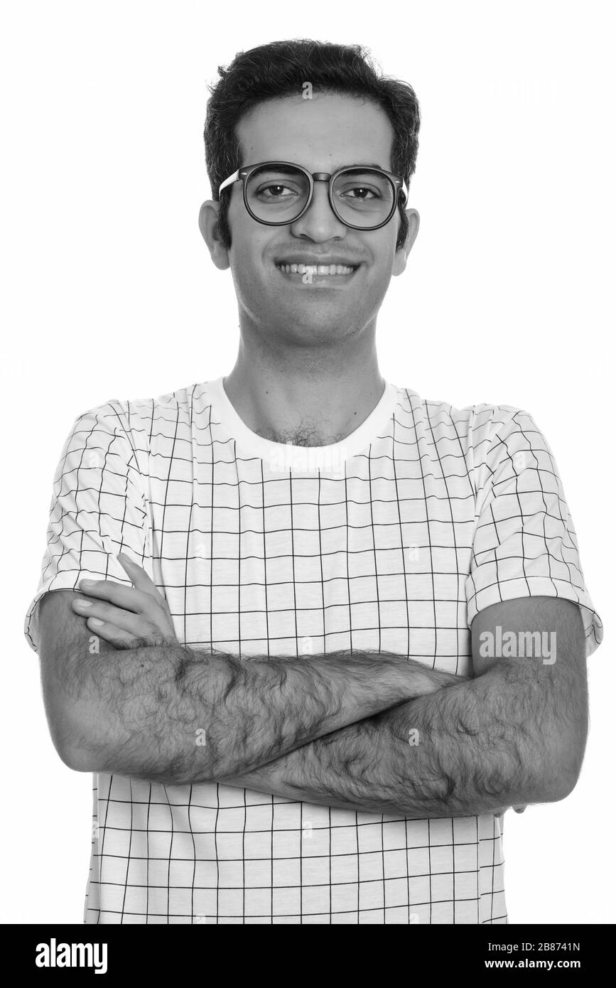 Portrait of happy young Persian nerd man smiling with arms crossed Stock Photo - Alamy