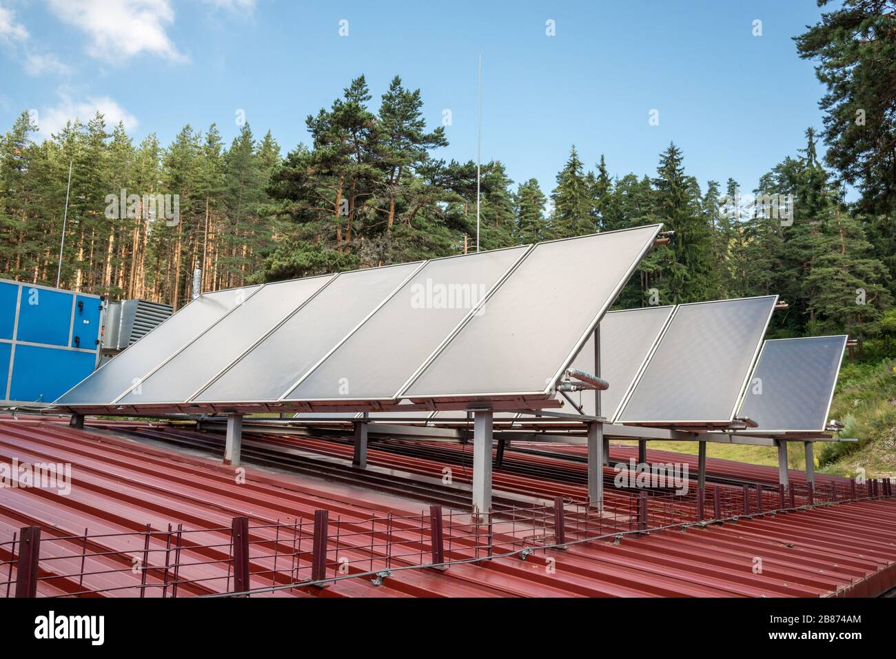 Solar panel on a red roof Stock Photo - Alamy
