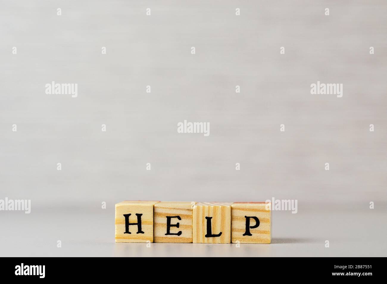 Help word made of letters and wooden cubes 3 Stock Photo - Alamy