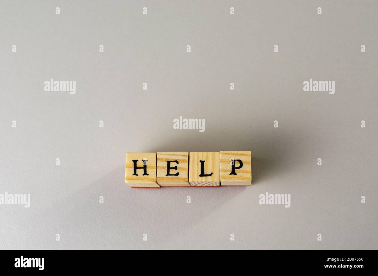 Help word made of letters and wooden cubes Stock Photo - Alamy