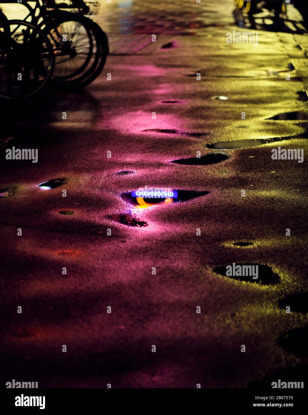 Overground sign reflecting on water puddle Stock Photo - Alamy