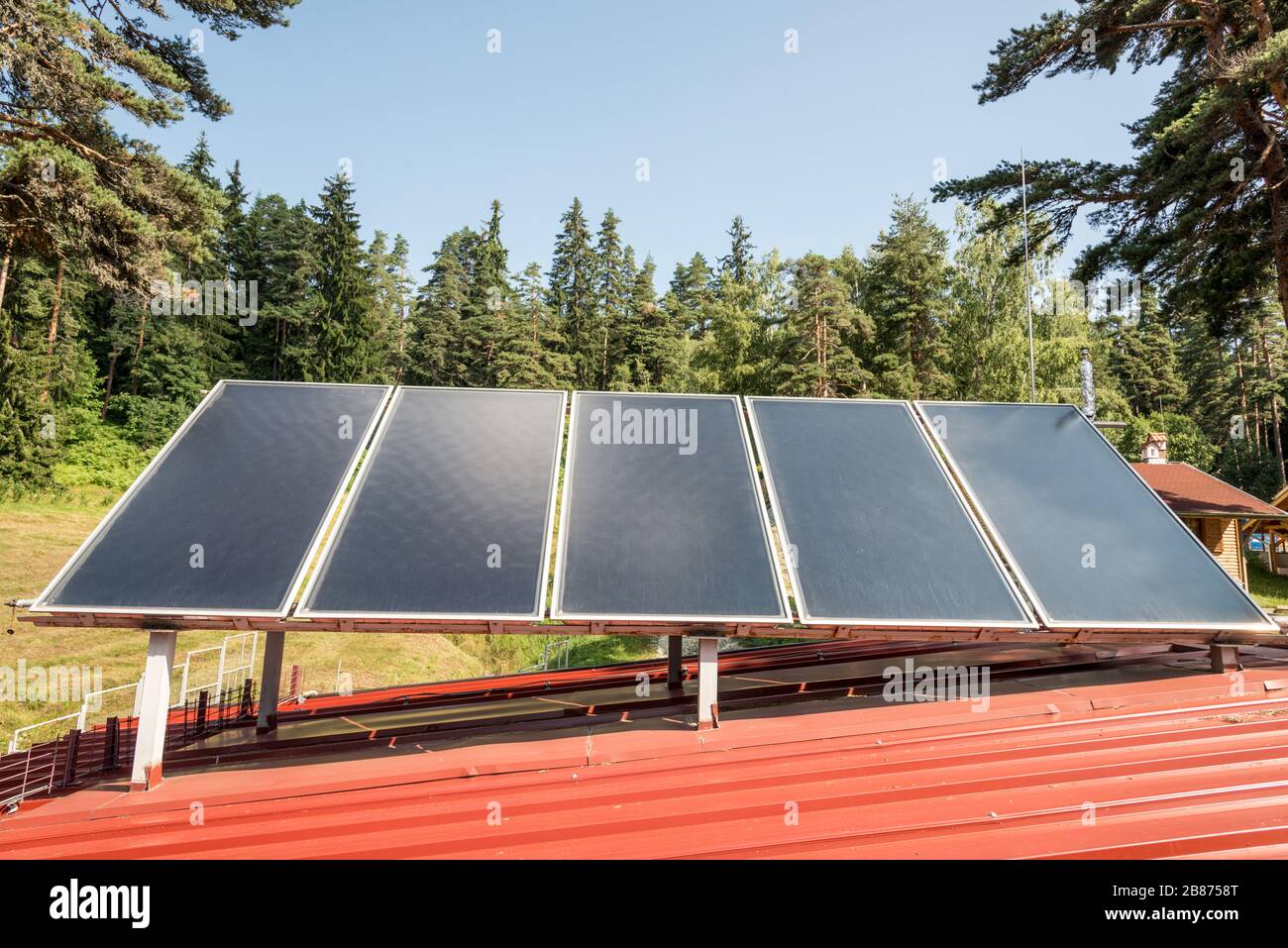 Solar panel on a red roof Stock Photo - Alamy