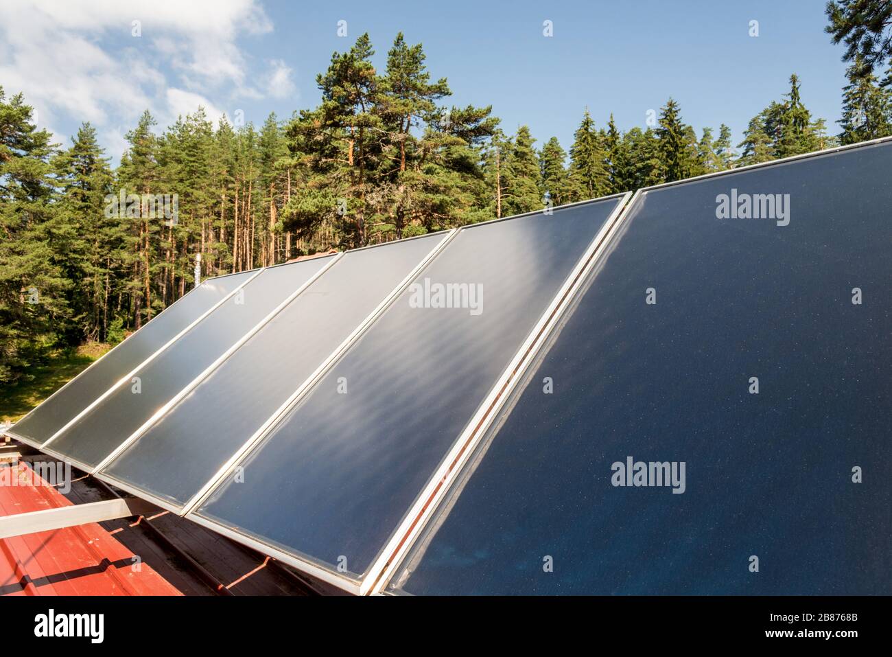Solar panel on a red roof Stock Photo - Alamy