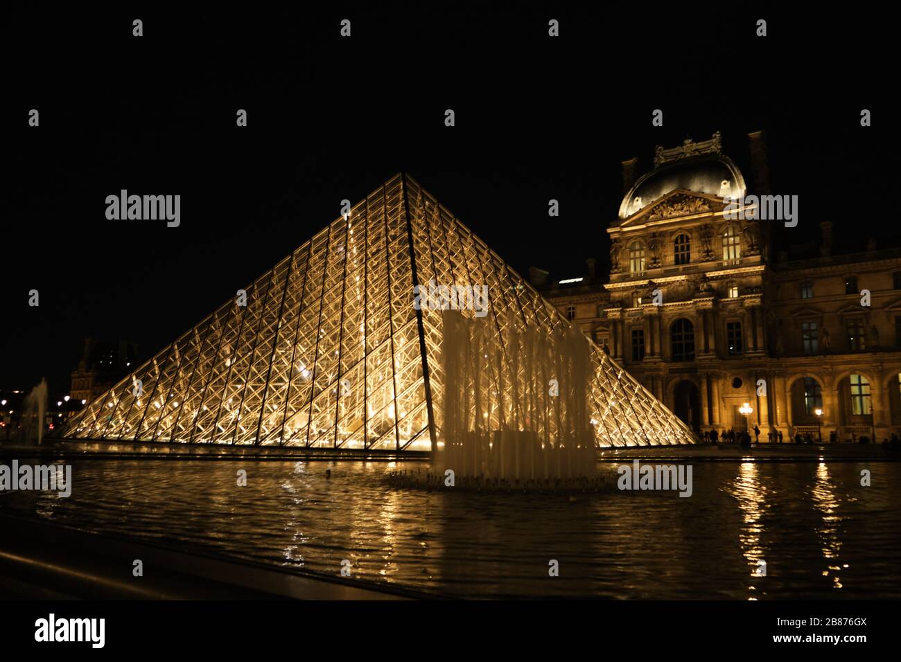 Louvre and Glass Pyramid at Night Stock Photo - Alamy