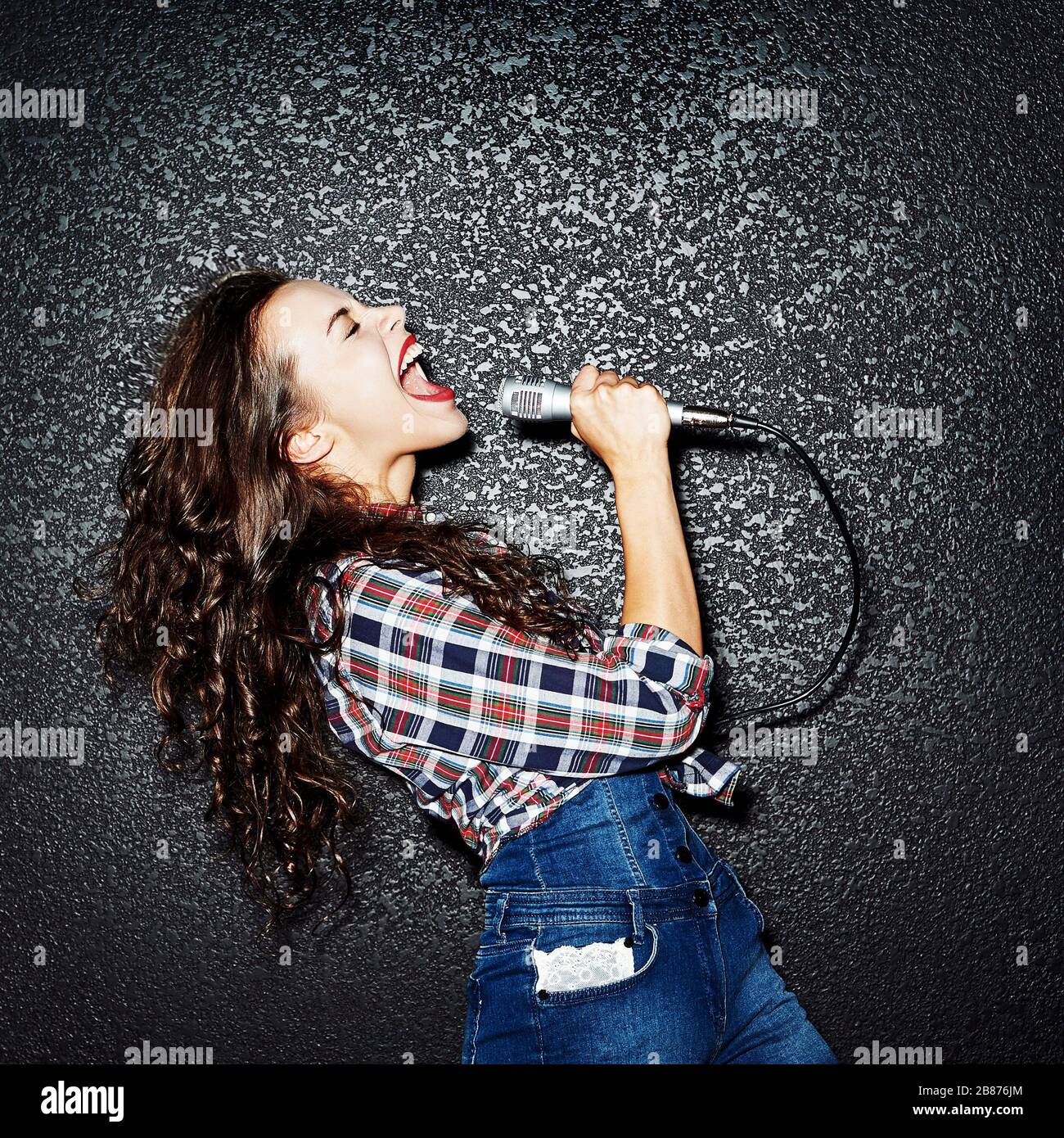 Karaoke party. Time to sing! Crazy casual curly chic girl singing with ...