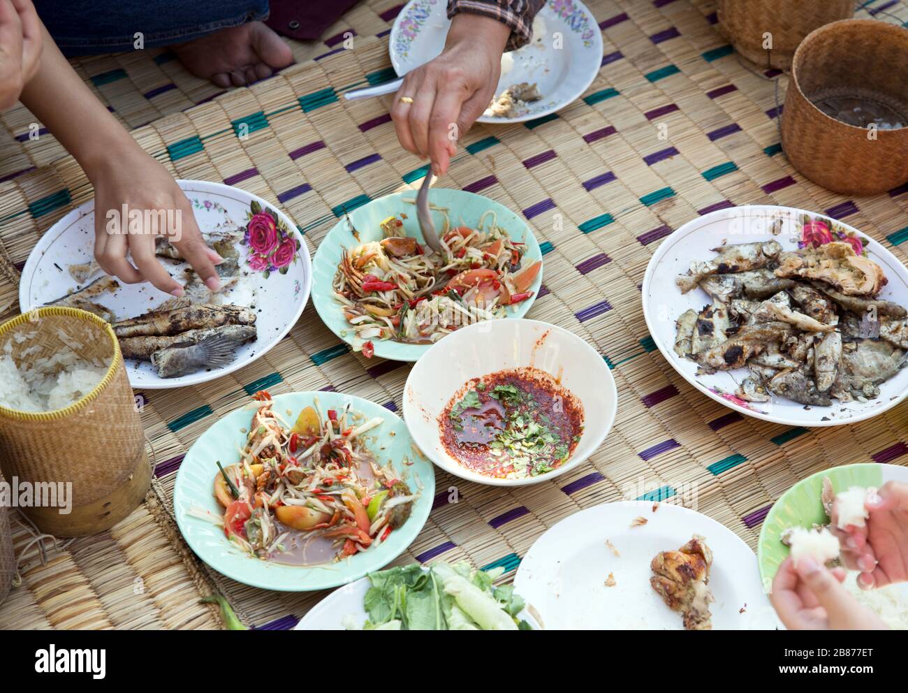 eating northern food menu with hand on rattan mat. Noreastern food of ...