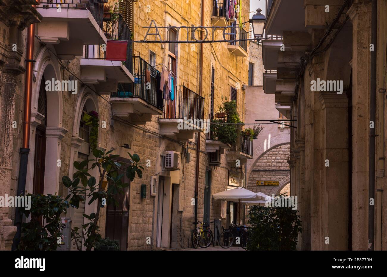 BARI, ITALY - FEBRUARY 20, 2020: old narrow street with plants and ...
