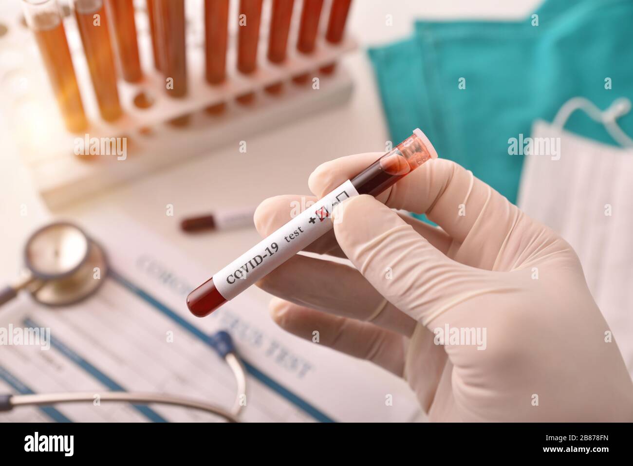 Medical analyst with covid-19 infected blood sample on laboratory table ...