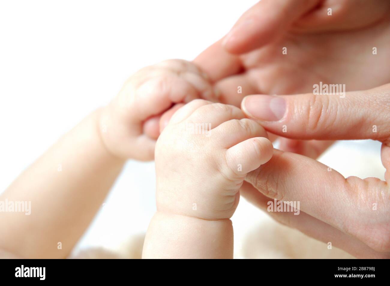 Hands of a small newborn baby hold on to the fingers of her mother s ...
