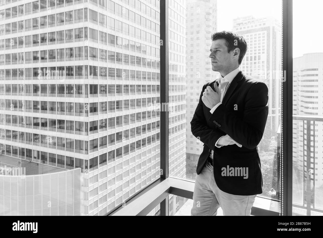 Businessman window city view Black and White Stock Photos & Images - Alamy