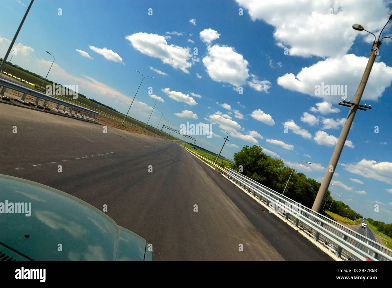Tilted angled shot of a smooth highway surrounded by beautiful summer ...