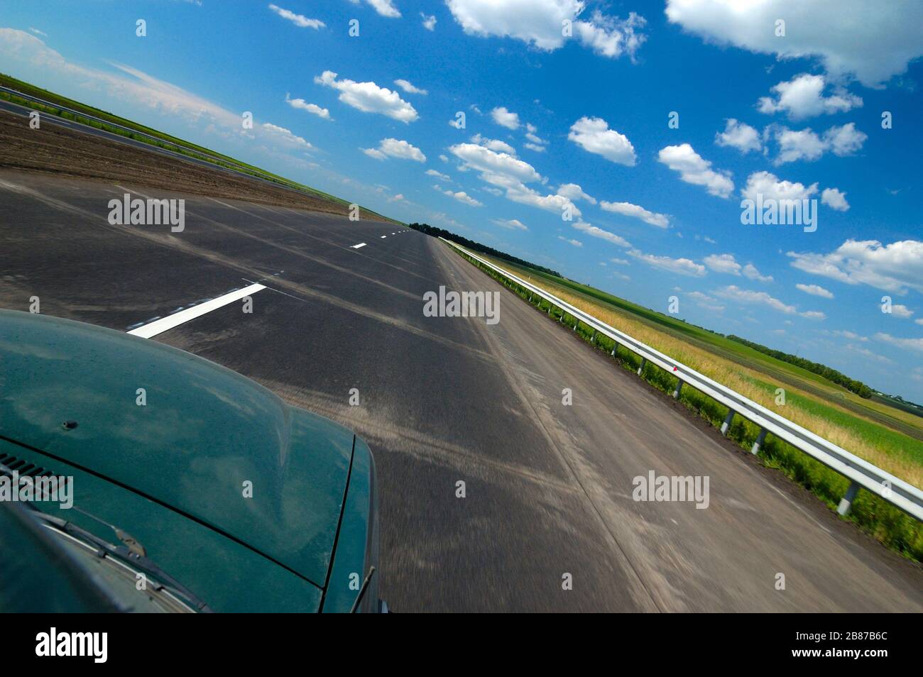 Side view of a car view is a smooth highway surrounded by beautiful ...