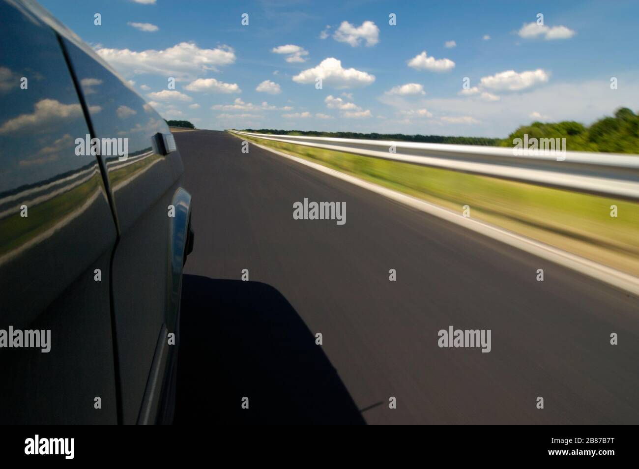 Side view of a car view is a smooth highway surrounded by beautiful ...