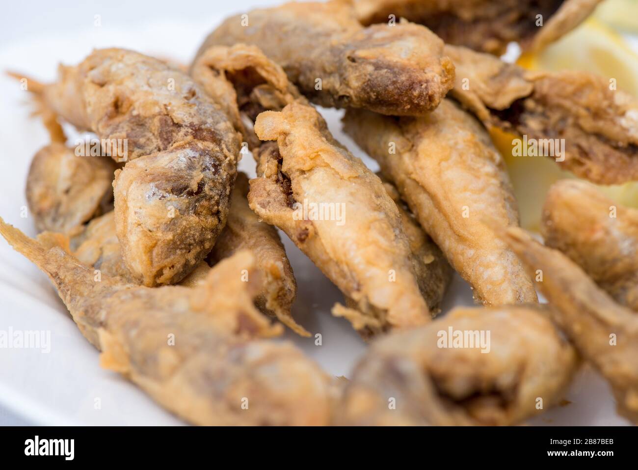 Fried scads fish on the white plate - selective focus Stock Photo - Alamy