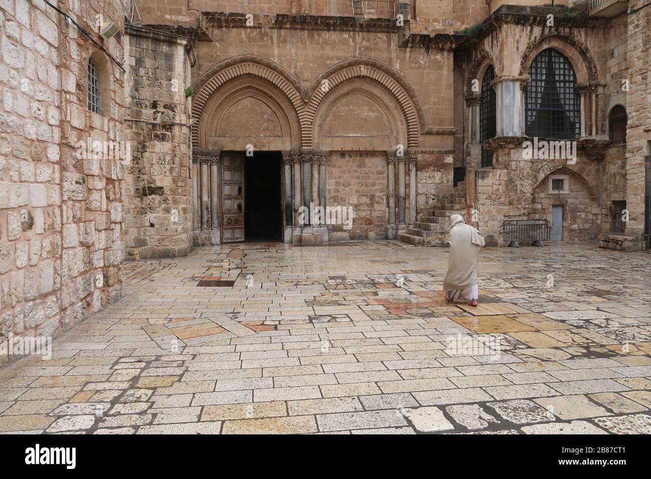 Christian pilgrim dressed as Jesus Christ enters the Church of Holy ...