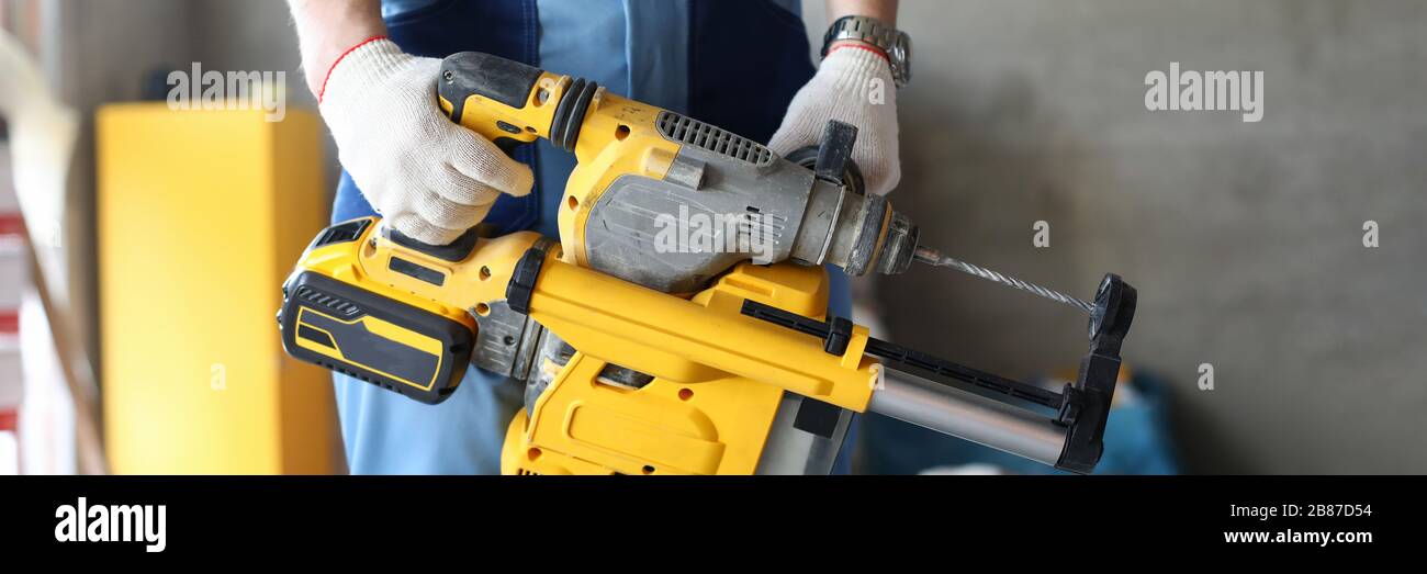 Male person holding drill Stock Photo - Alamy