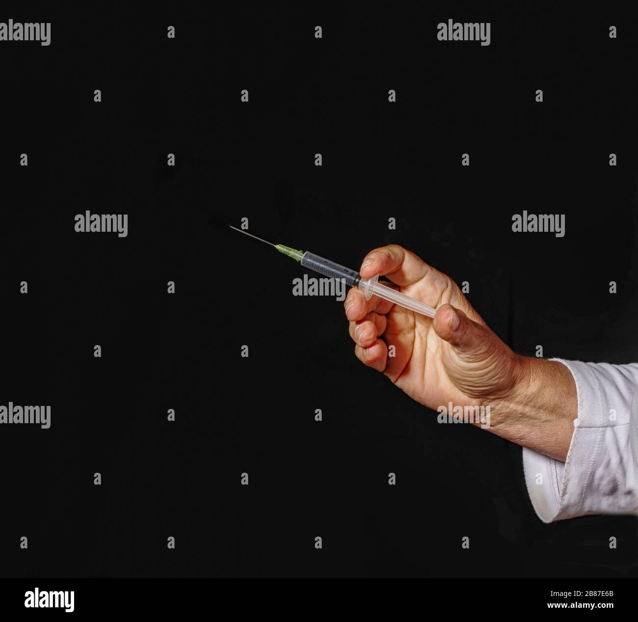 Female hand with syringe on black background Stock Photo - Alamy