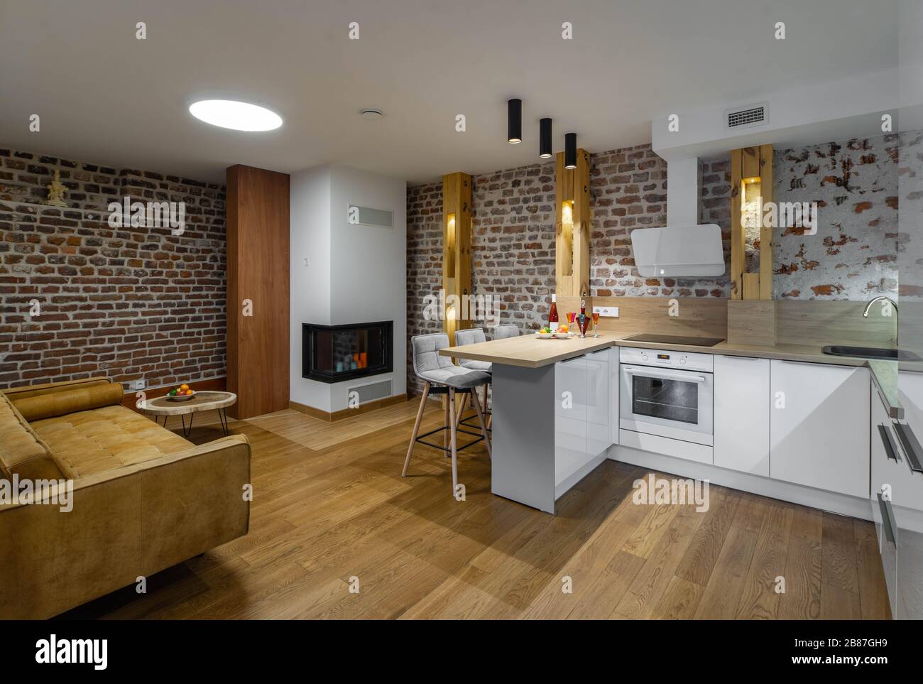 Modern contemporary loft interior of kitchen in studio apartment. Brick ...