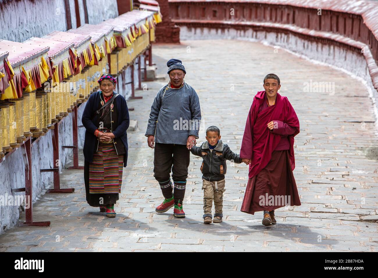 Family walking with monk at Samding Monastery in Gyangze, Tibet Stock ...