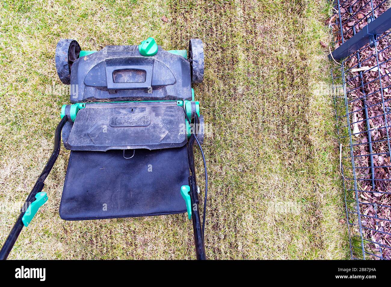 spring scarifying the lawn using verticutter machine Stock Photo - Alamy
