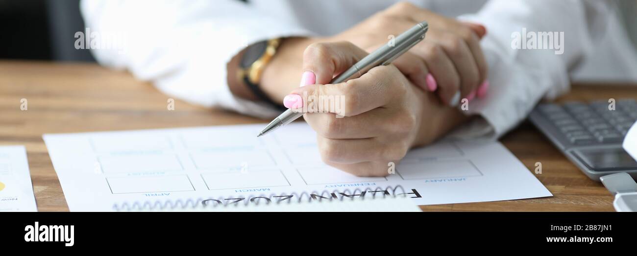 Female writing down in schedule Stock Photo - Alamy