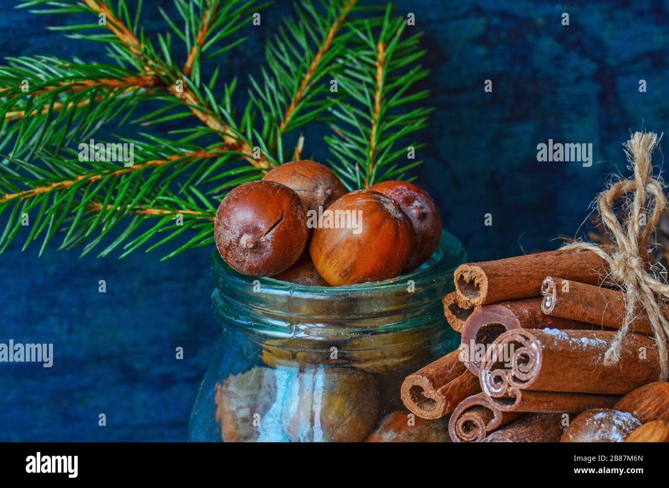 Christmas tree branches cones and nuts. Christmas wooden background ...