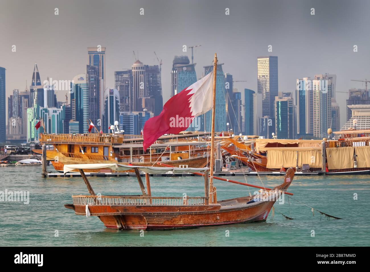 Qatari Flag waving on a Traditional Wooden Boat also known as Dhow at ...
