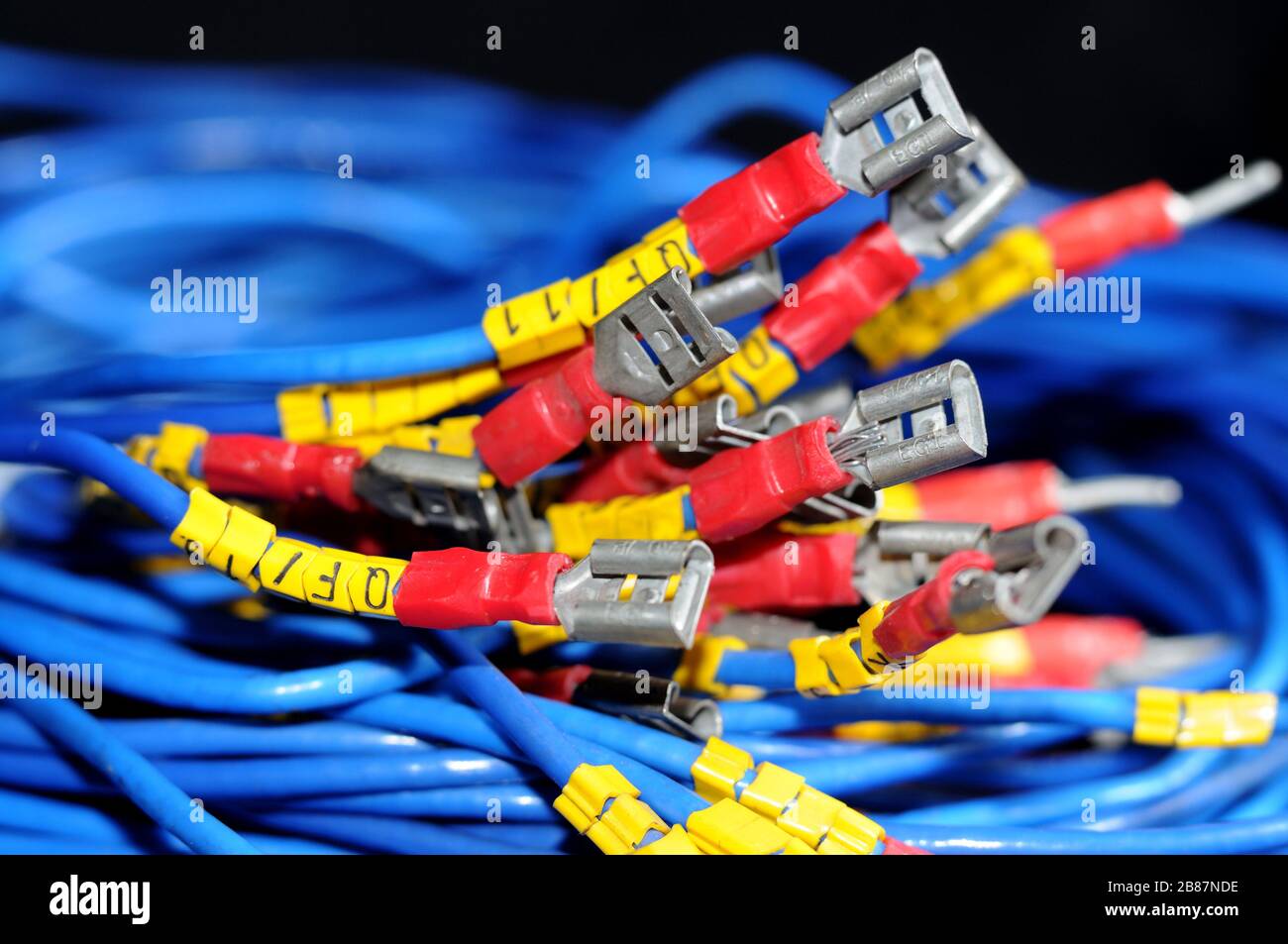 Close-up of a bundle of cut wires with metal connections sticking out ...