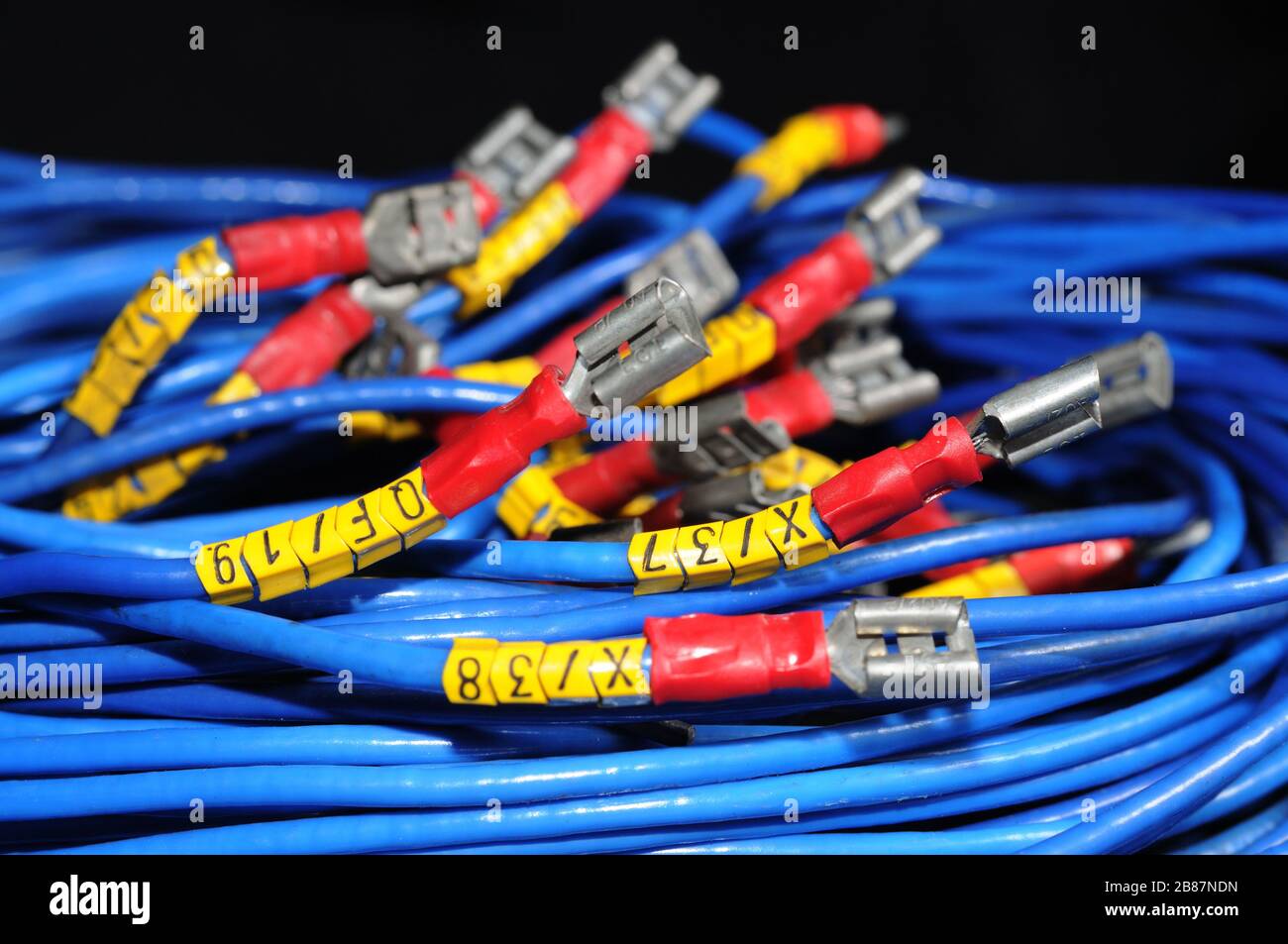 Close-up of a bundle of cut wires with metal connections sticking out ...