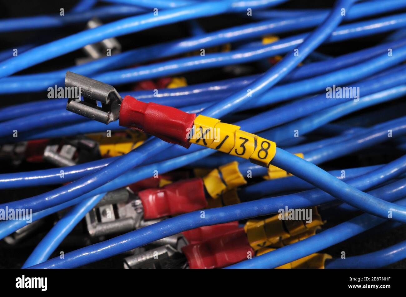 Close-up of a bundle of cut wires with metal connections sticking out ...