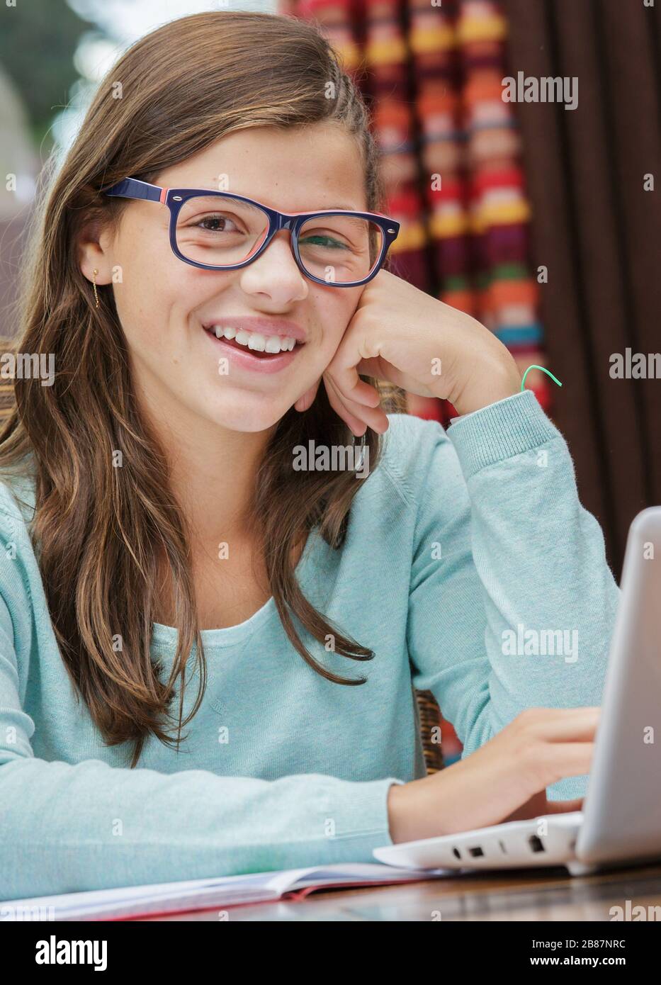 pretty student girl doing homework at home with a laptop Stock Photo ...