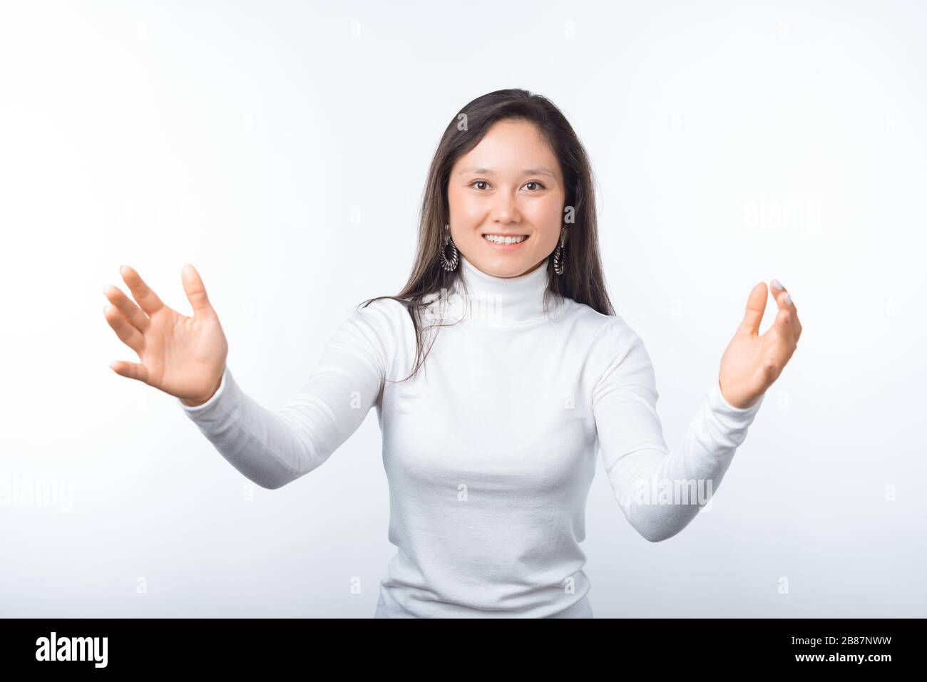 Photo of cheerful smiling woman making welcome gesture over white ...