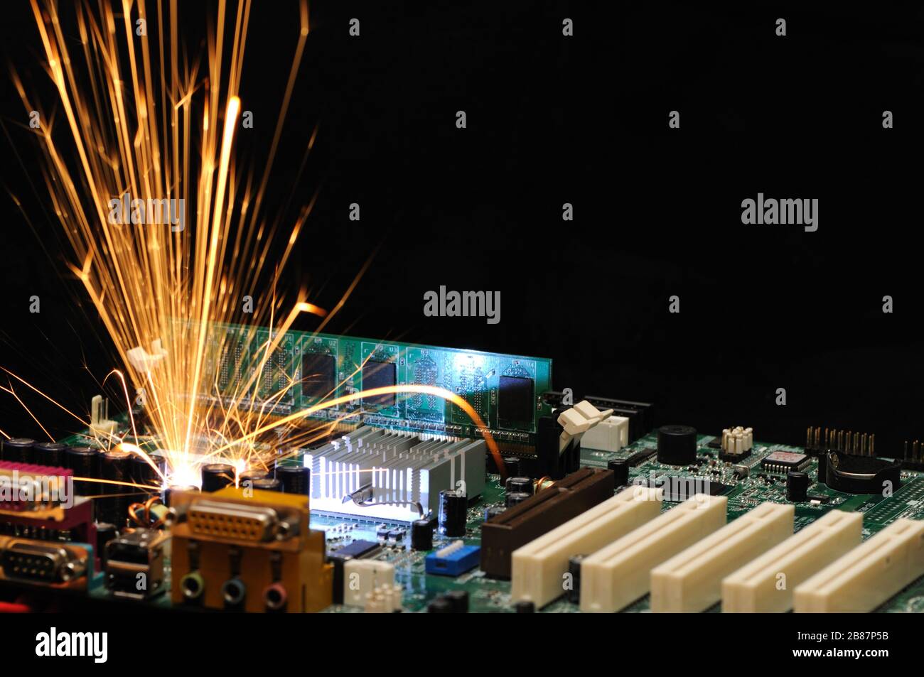 Bright burning sparks fly from the chip of complex electronic equipment ...