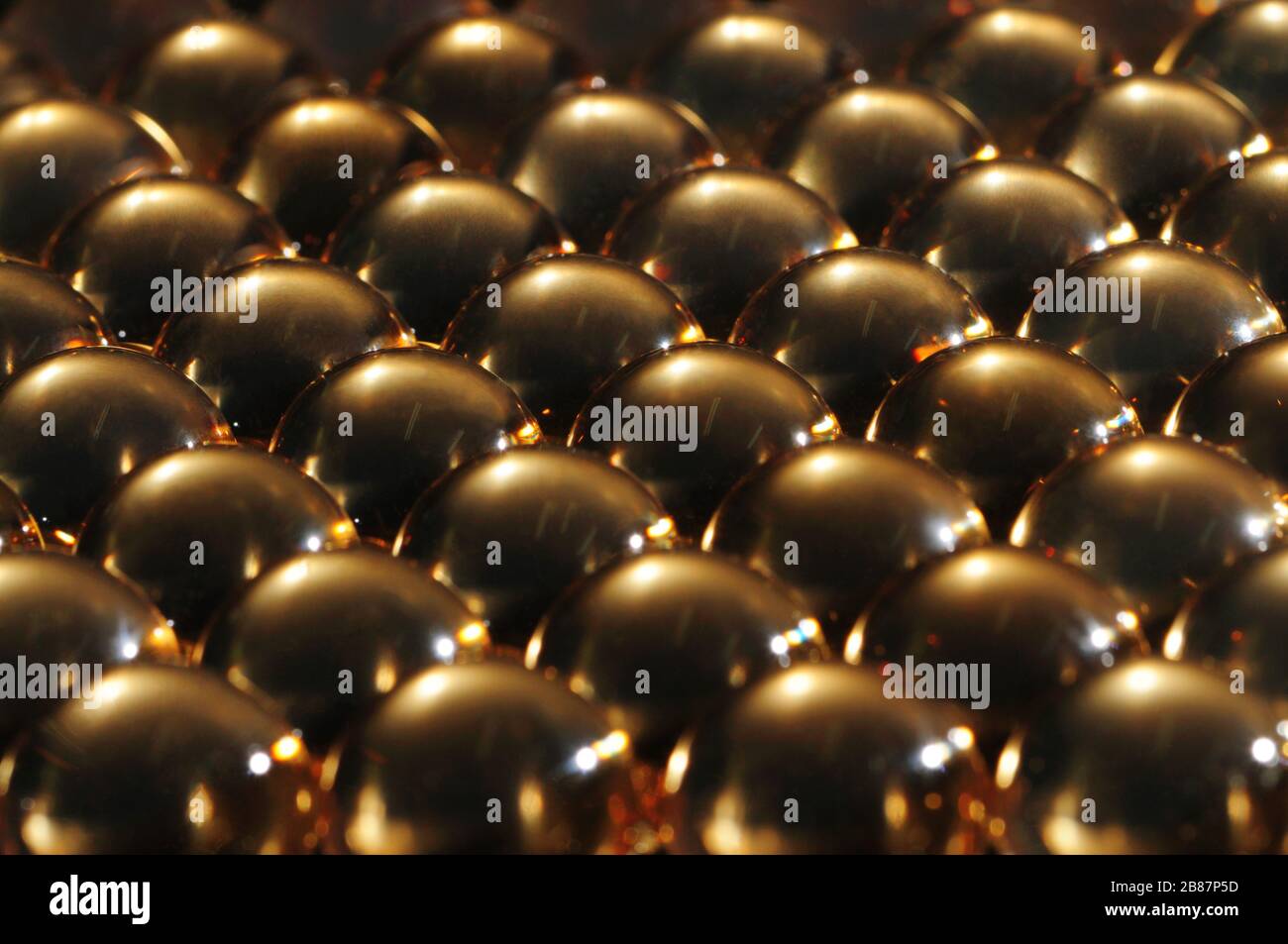 Close-up large golden shiny iron balls lie next to each other. The ...
