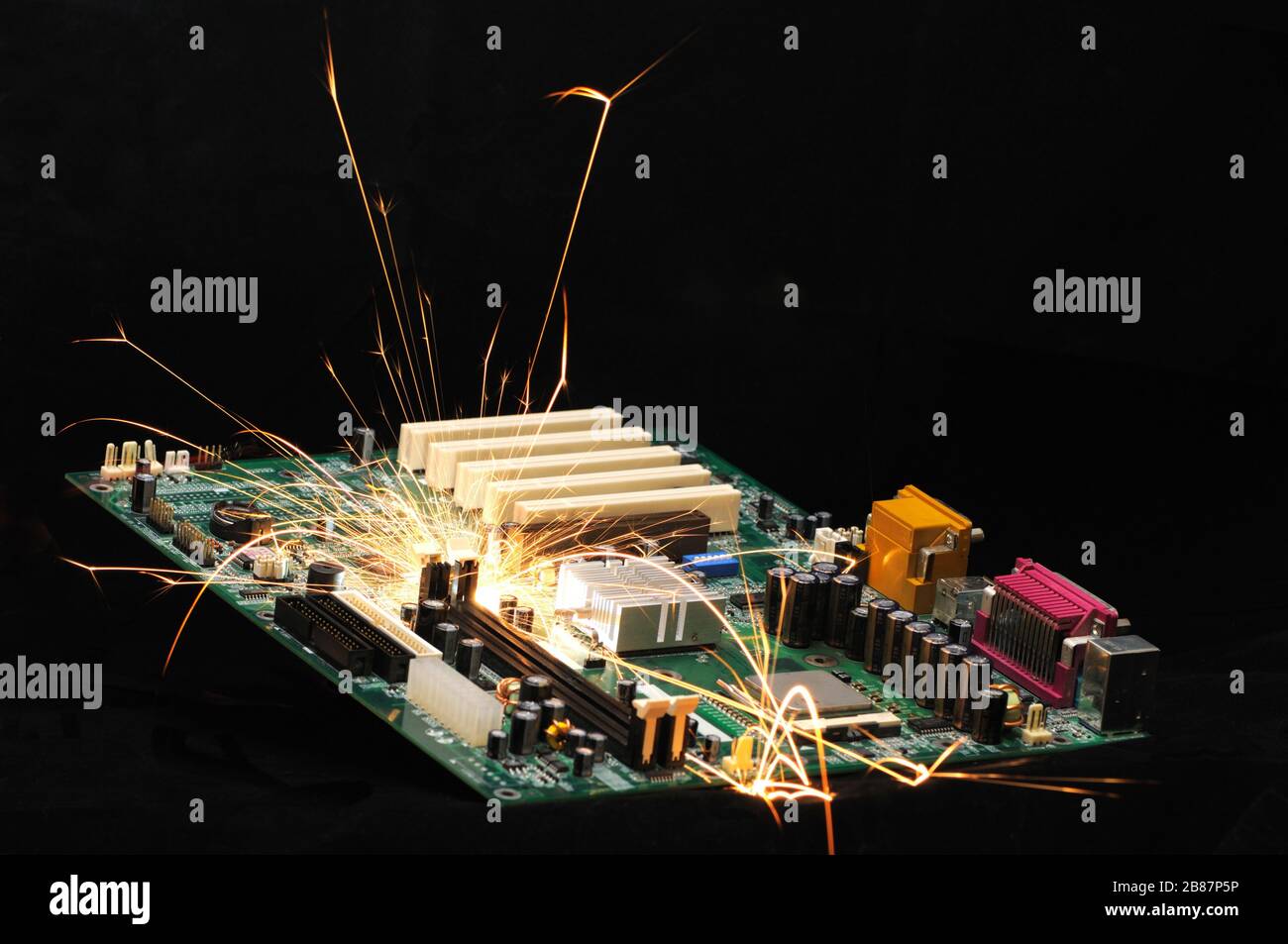 Bright burning sparks fly from the chip of complex electronic equipment ...
