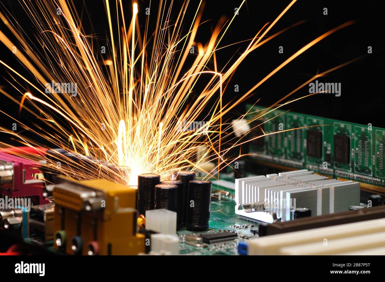 Bright burning sparks fly from the chip of complex electronic equipment ...