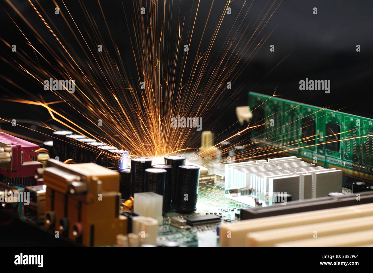 Bright burning sparks fly from the chip of complex electronic equipment ...