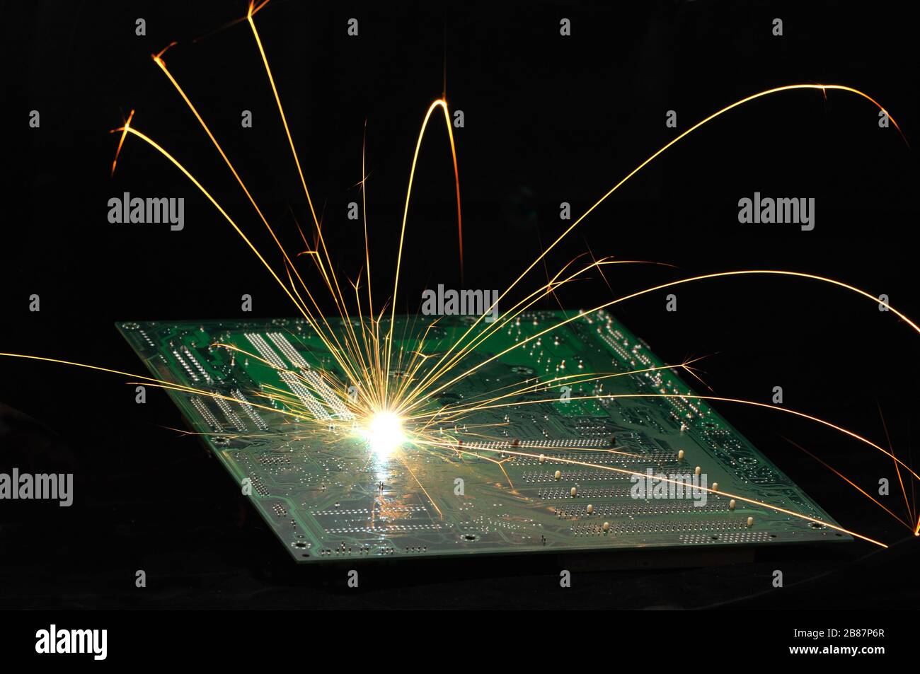 Bright burning sparks fly from the chip of complex electronic equipment ...