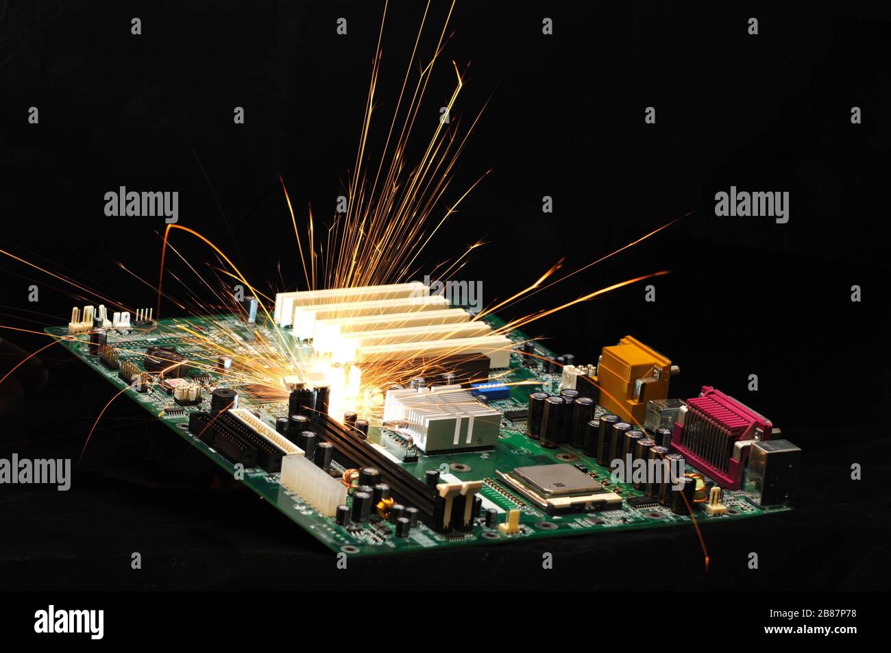 Bright burning sparks fly from the chip of complex electronic equipment ...