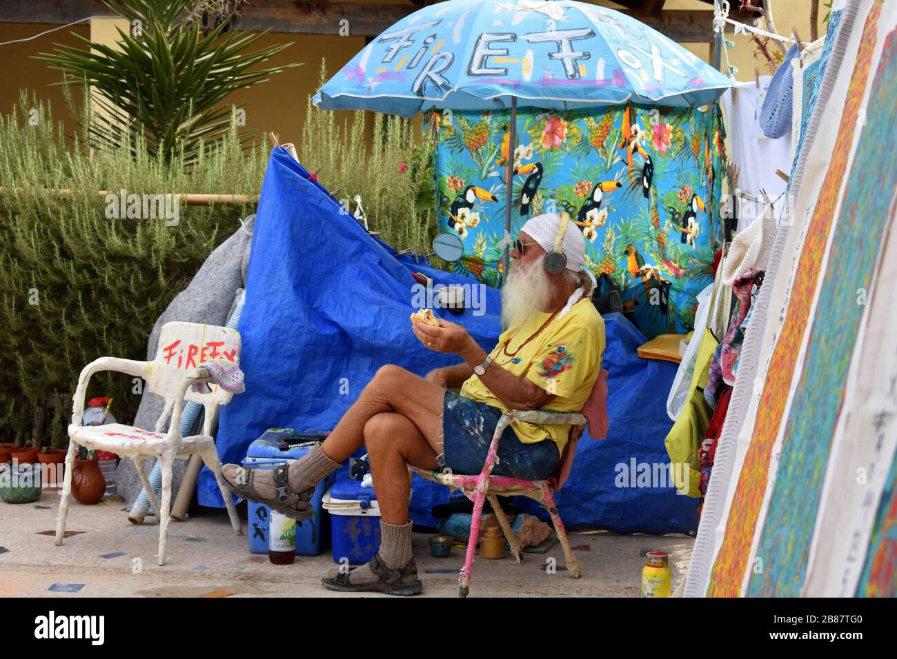 Colourful market stallholder at the hippie market, El Pilar de la Mola ...