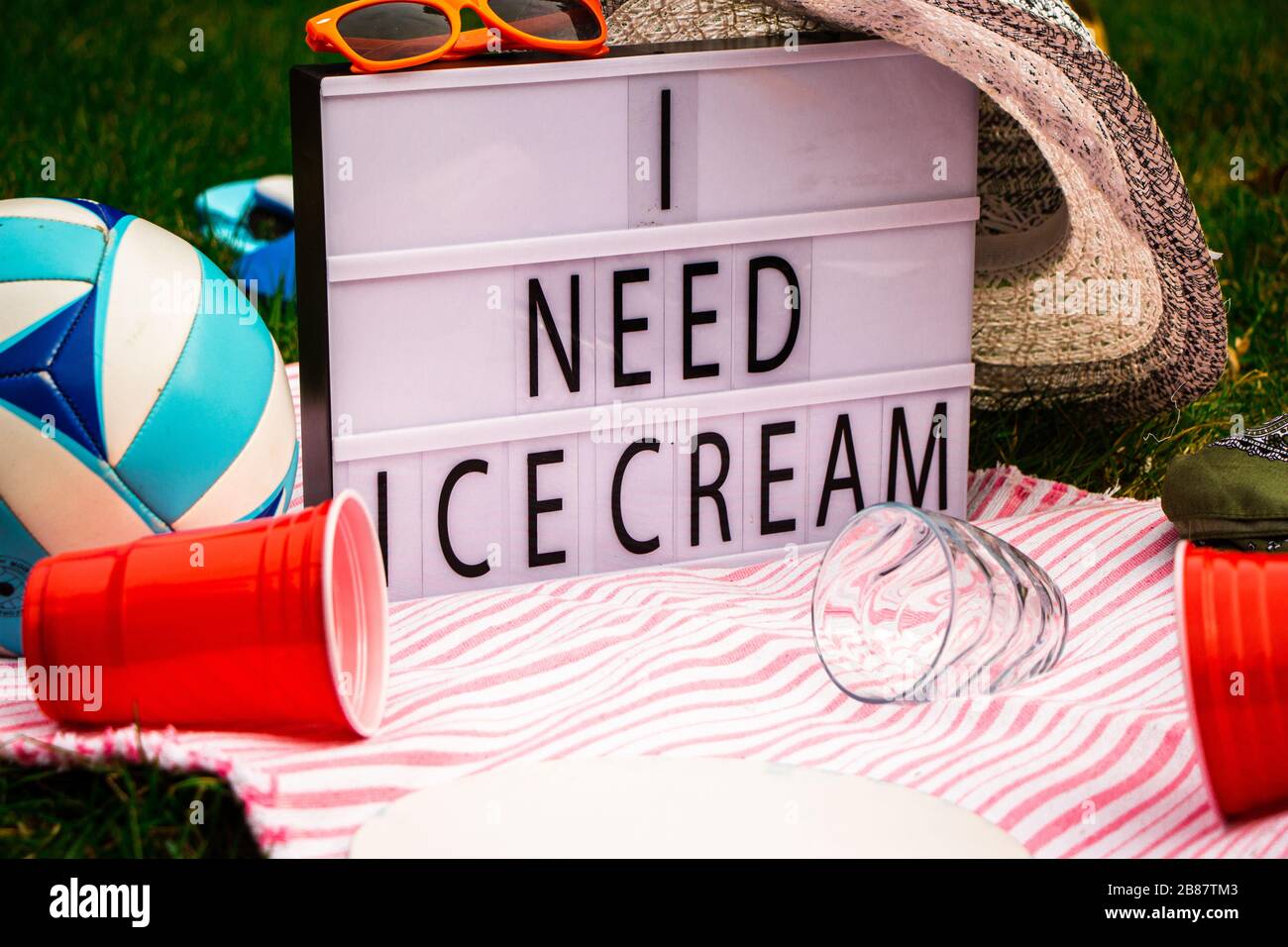 A lightbox surrounded by picnic accessories. The lightbox spells: "I ...