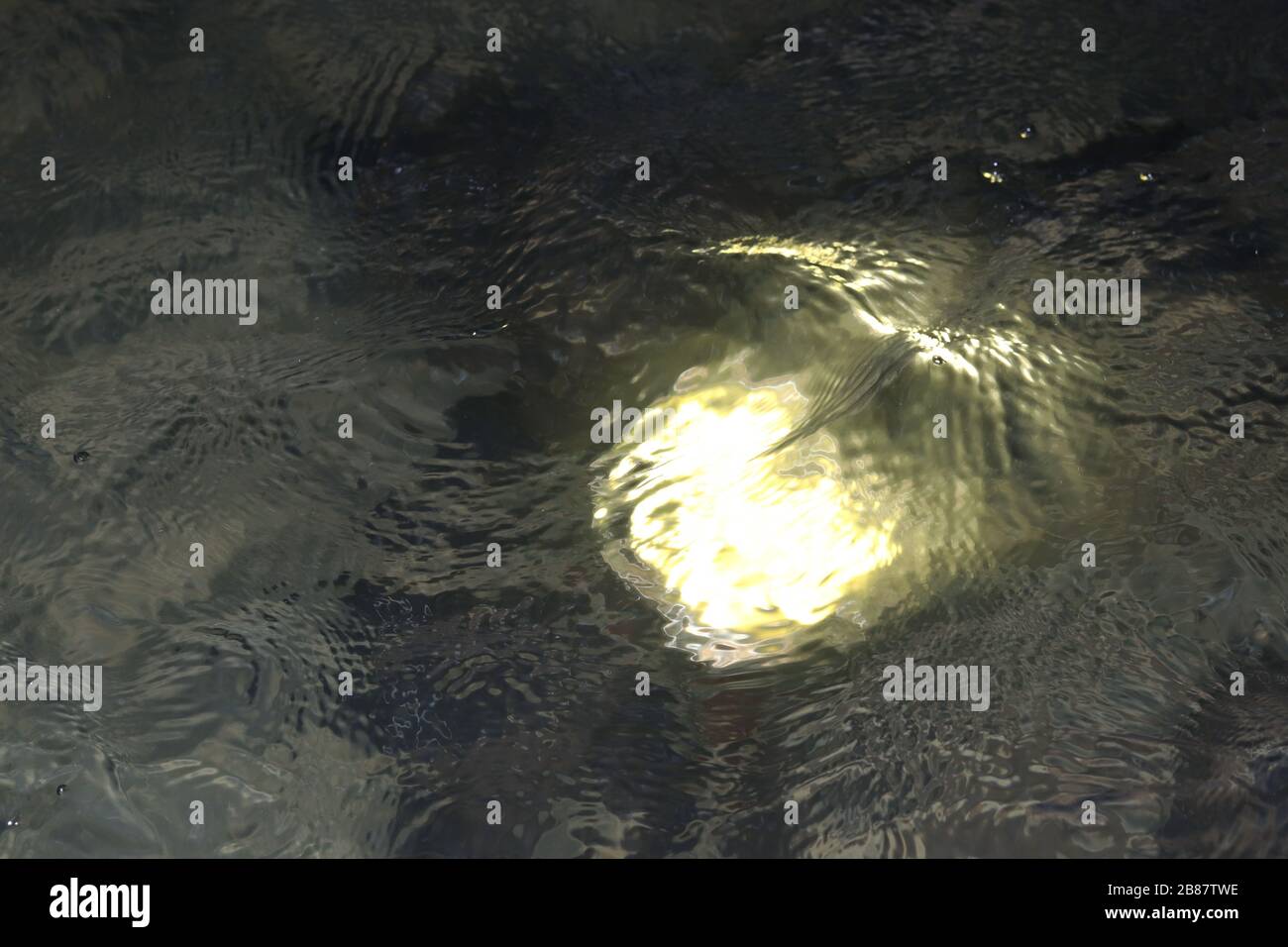 water surface with lighting lamp in swimming pool, underwater lamp ...