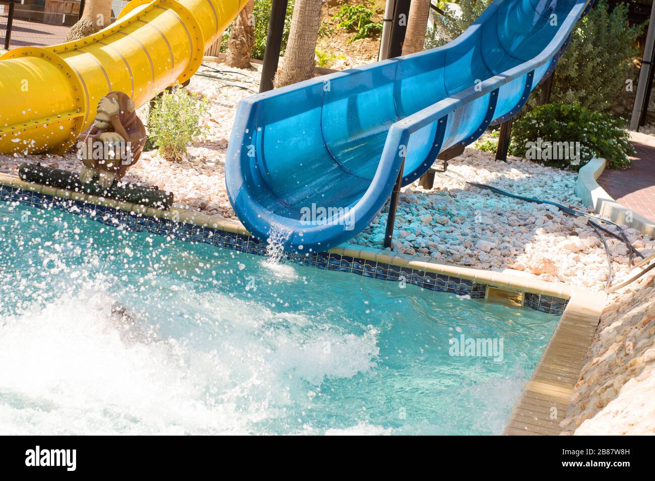 End of blue water slide in swimming pool with splashing water Stock ...