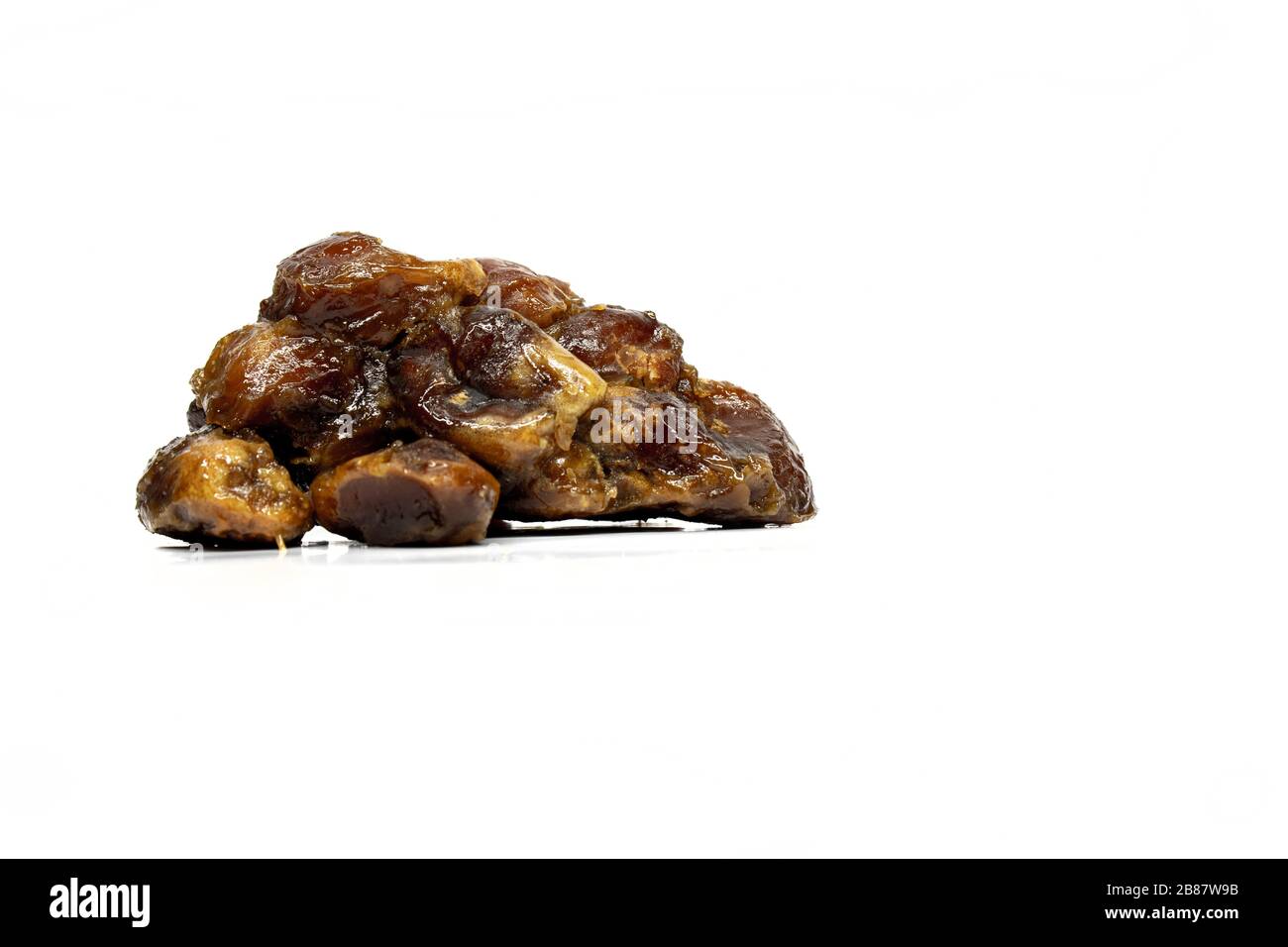 Dates coated with melted jaggery Stock Photo - Alamy