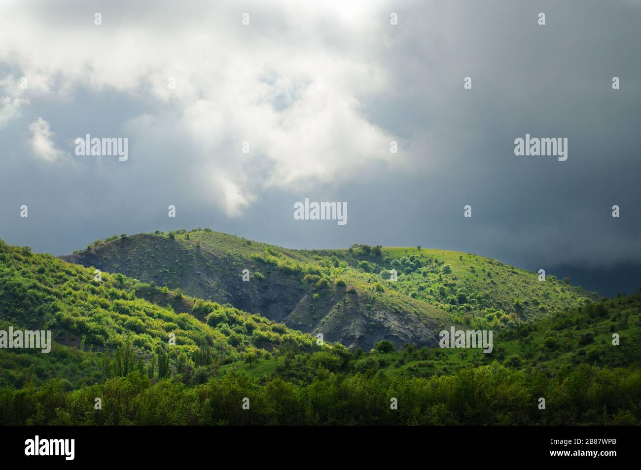 Mountain ranges and hills covered with forest, bushes and plants. Sky ...