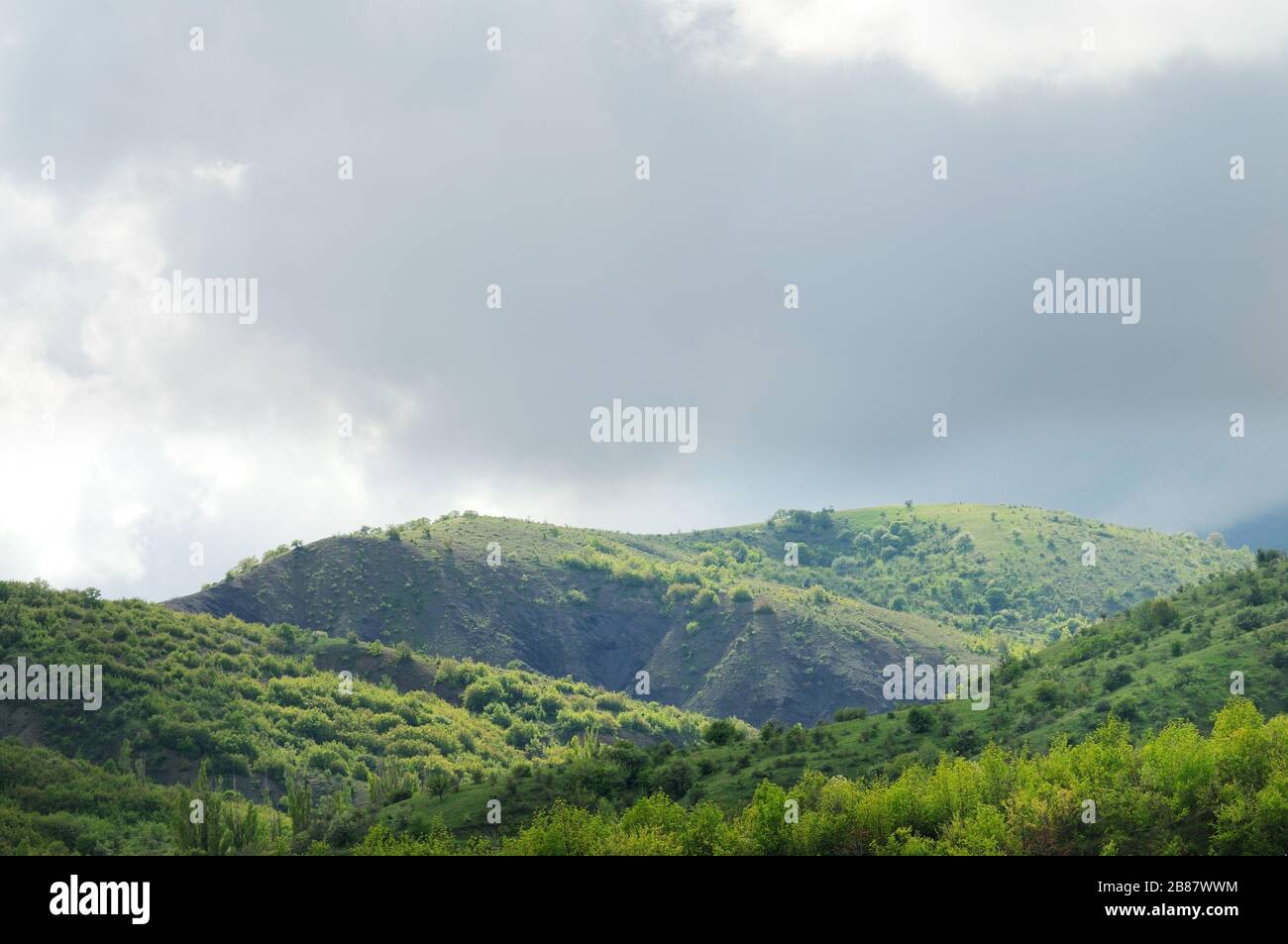 Mountain ranges and hills covered with forest, bushes and plants. Sky ...