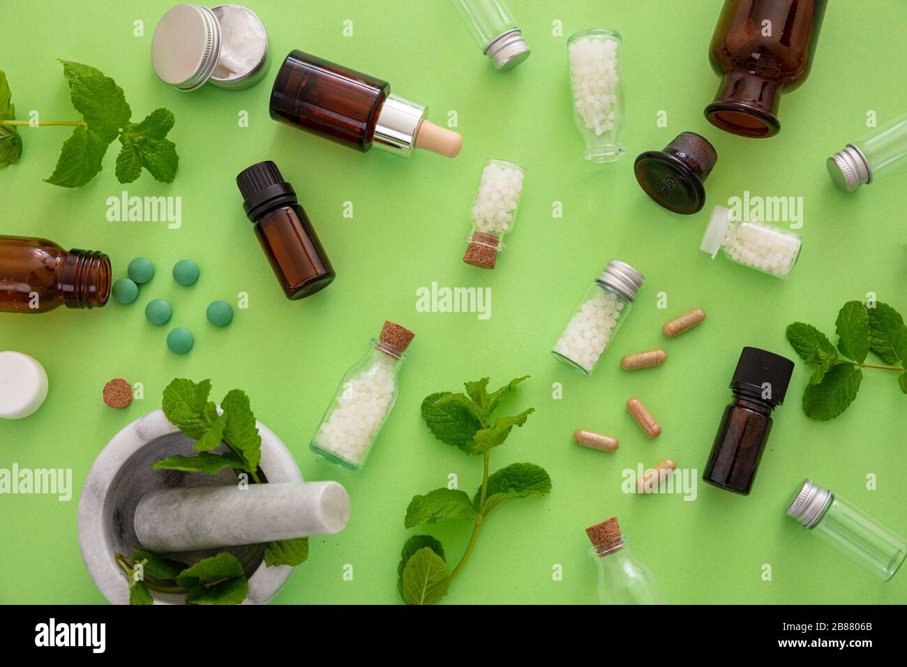 Homeopathy concept. Glass bottles and vials with homeopathic globules ...
