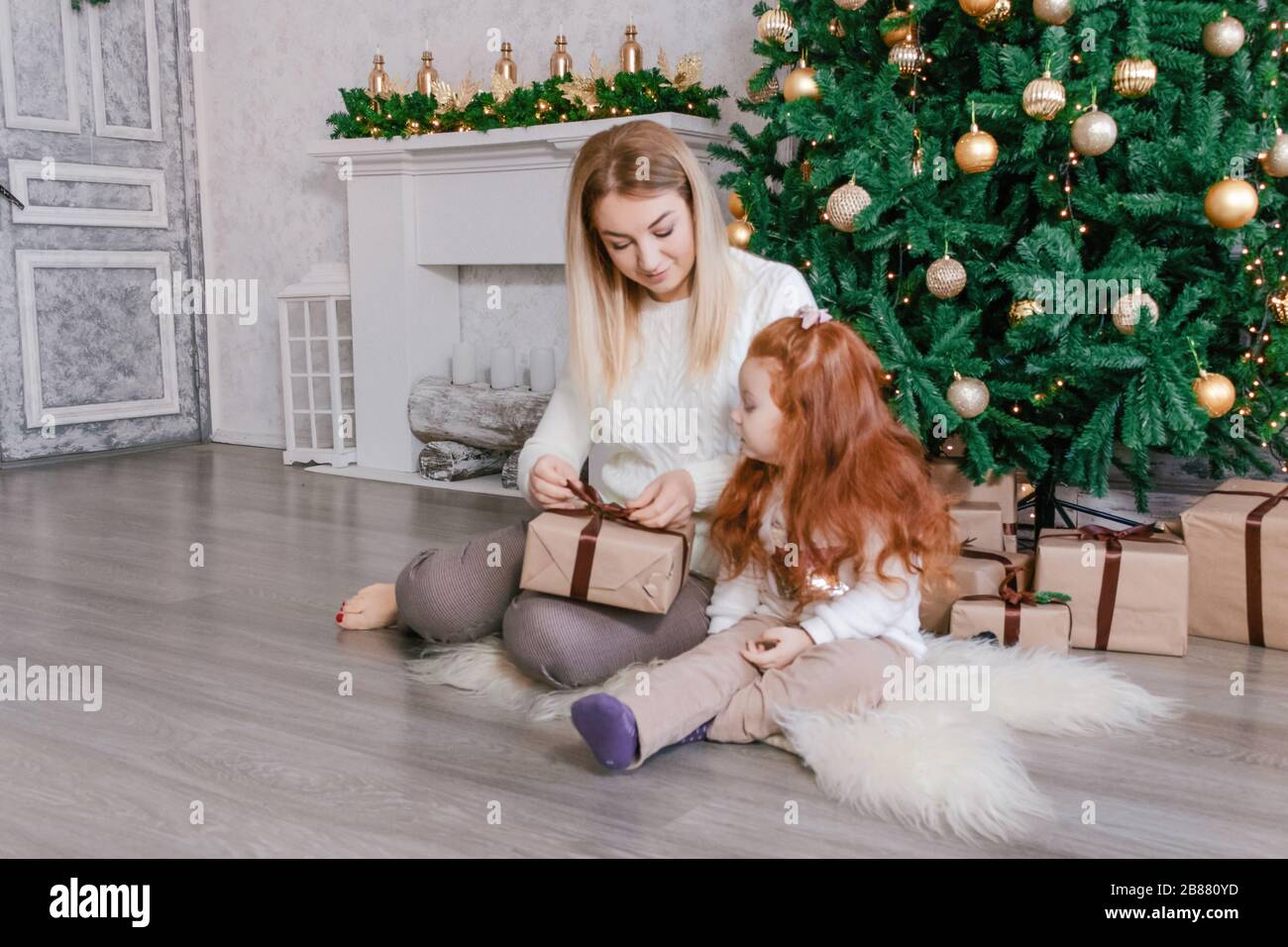 Family opening Christmas presents at home photo Stock Photo - Alamy